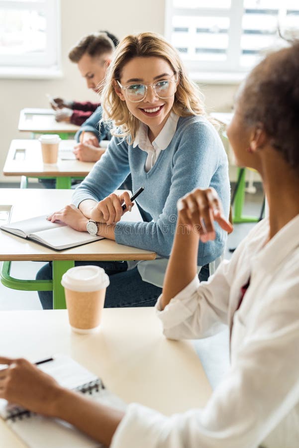 Multicultural Students with Notebooks Talking in College Stock Photo ...