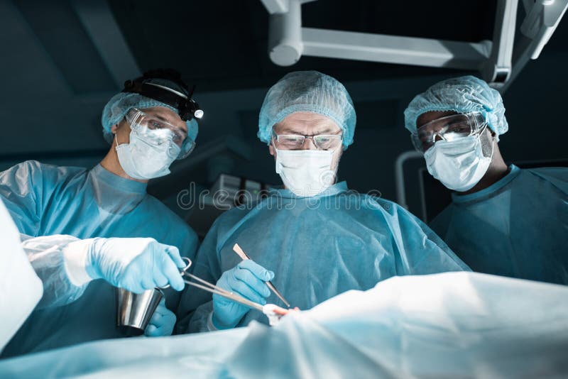 Multiethnic Surgeons Operating Female Stock Photos - Free & Royalty ...