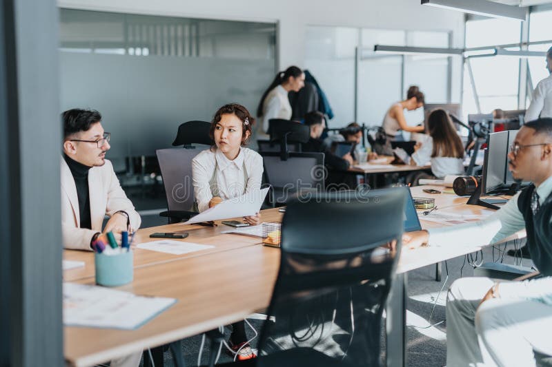 Multicultural Team Collaborating in a Modern Open Office Space Stock ...