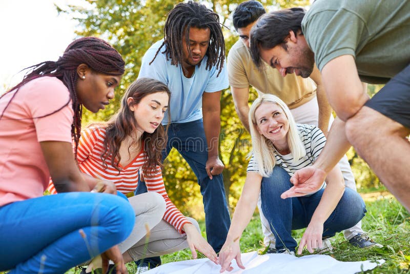 Multicultural Team Doing Geocaching with a Map Stock Photo - Image of ...