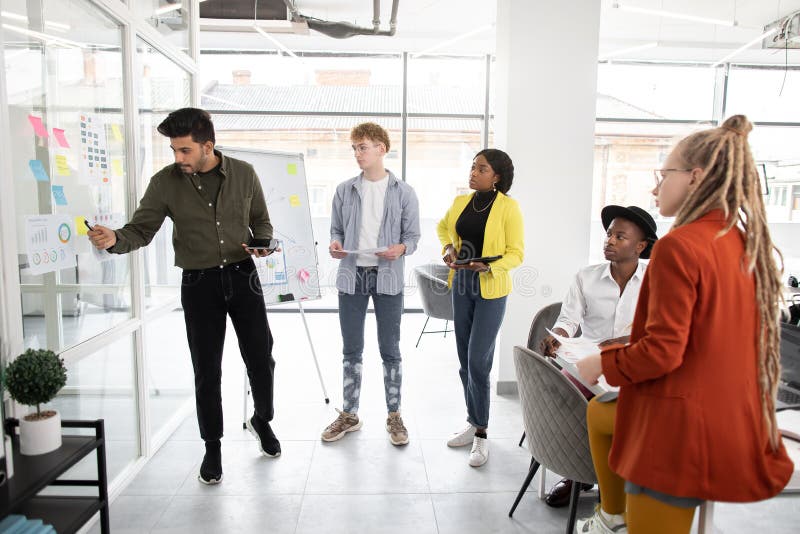 Two Multicultural Workers Discussing Corporate Work Plan Standing in ...
