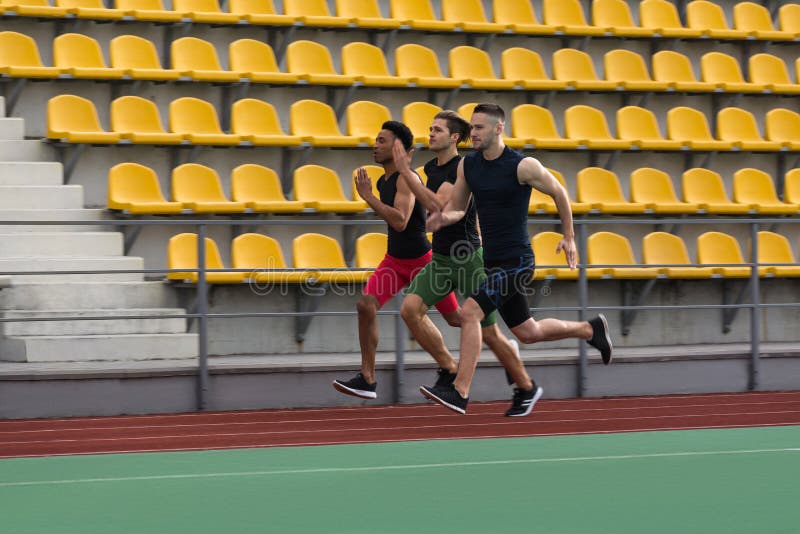 Multiethnic Athlete Group Run on Running Track Outdoors Stock Image ...