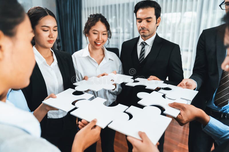 Multiethnic Business People Holding Jigsaw Pieces Together. Meticulous ...