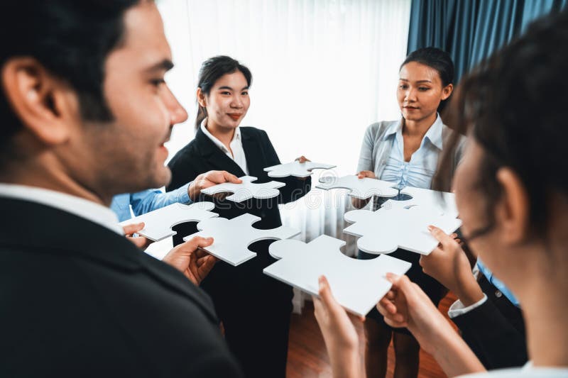 Multiethnic Business People Holding Jigsaw Pieces Together. Meticulous ...