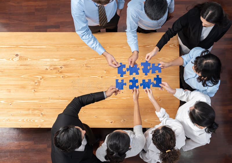Multiethnic Business People Holding Jigsaw Pieces Together. Meticulous ...