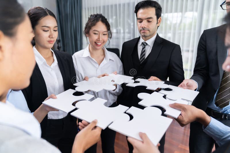 Multiethnic Business People Holding Jigsaw Pieces Together. Meticulous ...