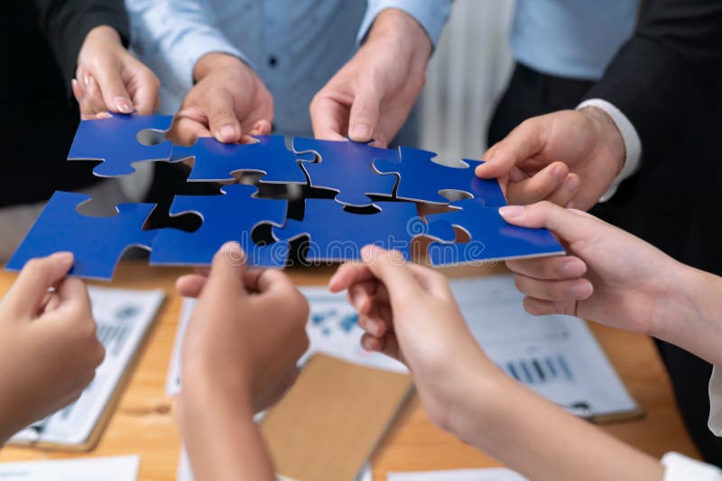 Multiethnic Business People Holding Jigsaw Pieces Together. Meticulous ...