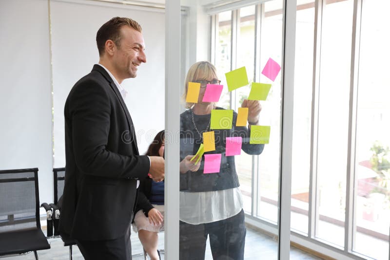 Multiethnic Business People Using Post it Notes for Brainstorming or ...