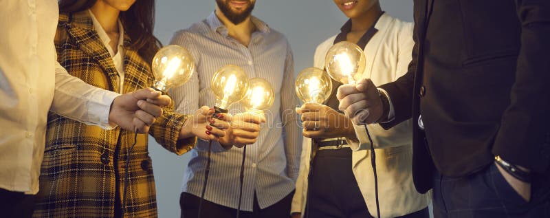 Multiethnic Business Team Joining Glowing Light Bulbs As Metaphor for ...