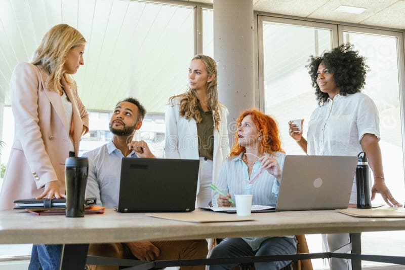 Multiethnic Business Team Sharing Ideas and Discussing a Work Project ...