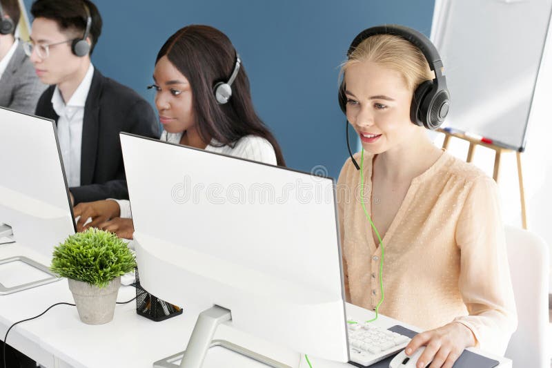 Multiethnic Call Centre Operators with Headsets Talking To Clients ...