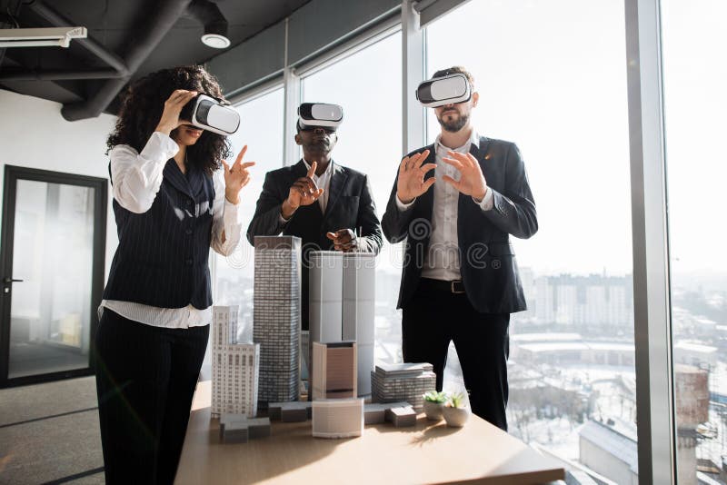 Group of Developers Using Virtual Reality Simulators, Standing Around ...