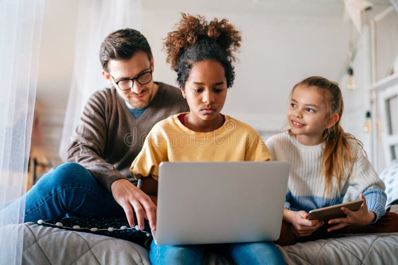 Multiethnic Father and Children Using Electronic Tablet Home ...