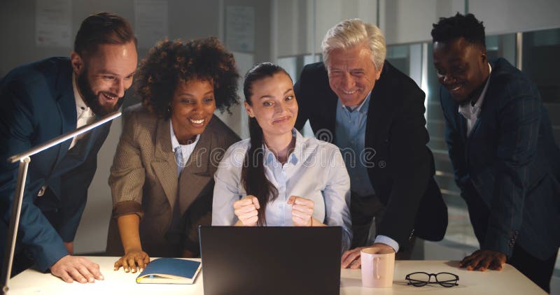 Multiethnic Group of Business People with Computer in Dark Office ...
