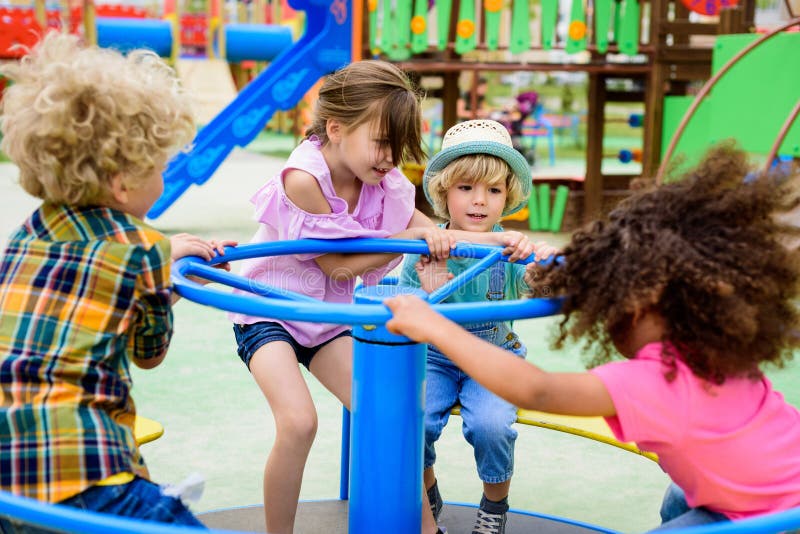Multiethnic Group of Little Kids Riding on Carousel Stock Image - Image ...