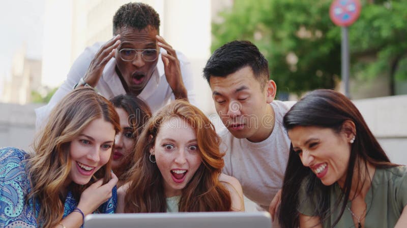 Multiethnic Group of People Looking at a Laptop with Surprised ...