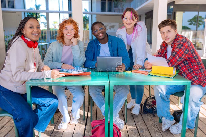Multiethnic Group of Students Sitting with a Laptop Gleefully Looking ...