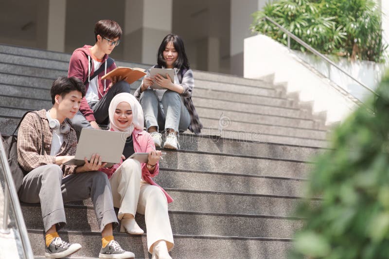 A Multiethnic Group of University Students is Studying Together while ...