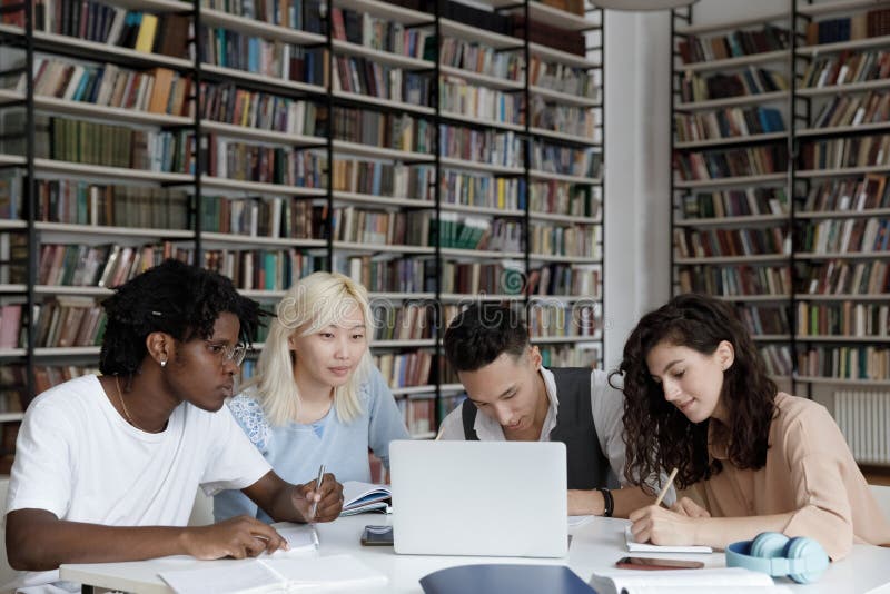 Multiethnic Group of University Students Working Together at Laptop ...