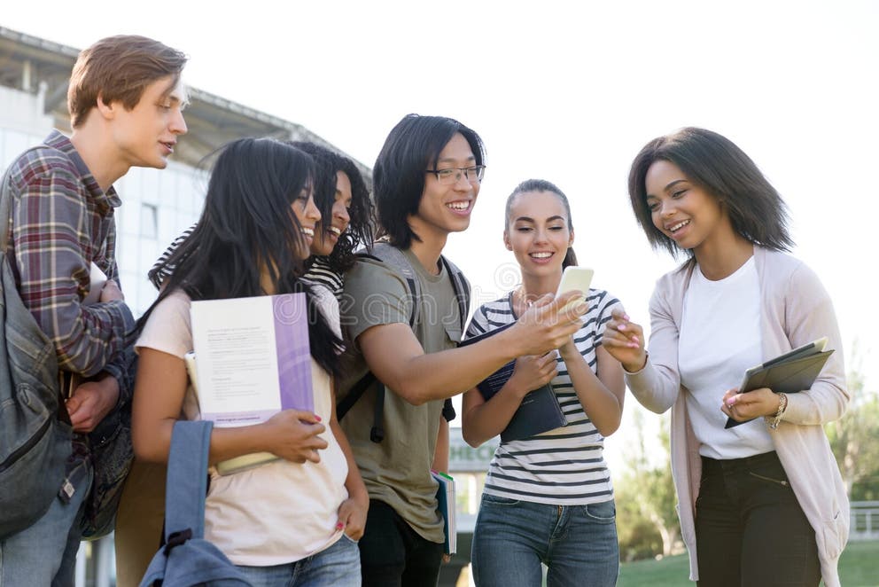 Multiethnic Group of Young Happy Students Using Mobile Phone Stock ...