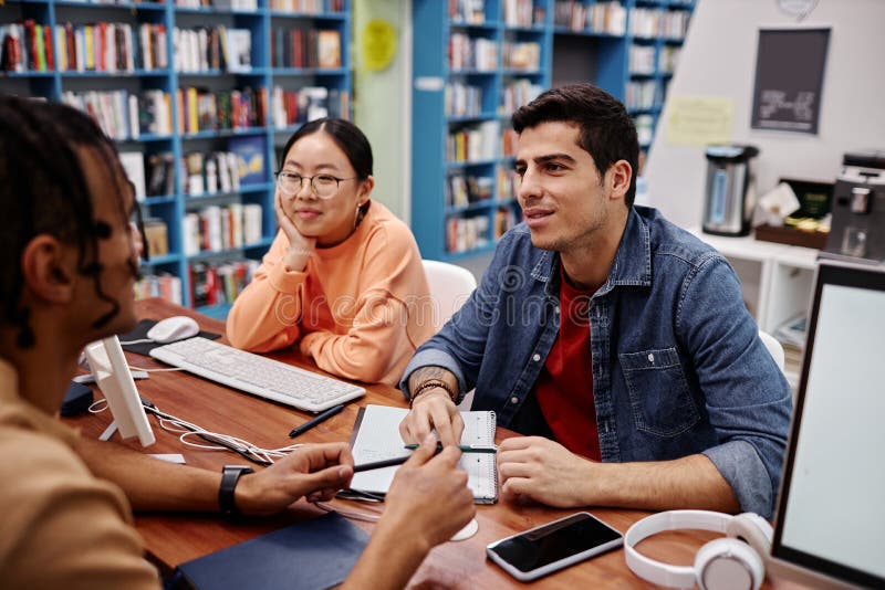 Multiethnic Group of Young People Studying Together in College Library ...