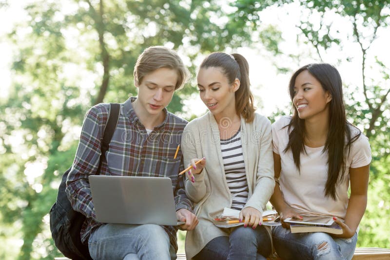 Multiethnic Group of Young Smiling Students Using Laptop Computer Stock ...