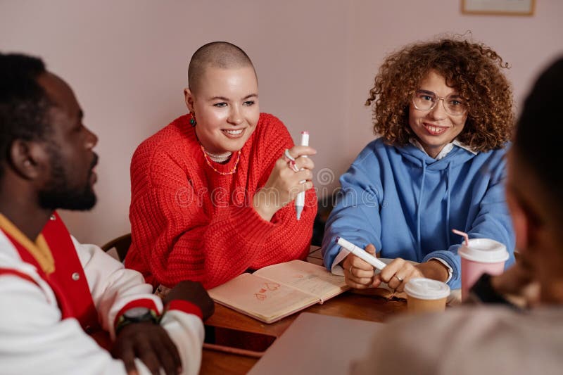 Multiethnic Group of Young Students Sitting at Table in College Stock ...