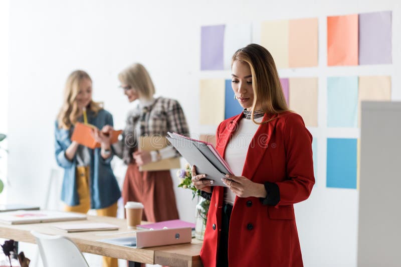 Multiethnic Magazine Editors Working with Documents on Clipboard in ...