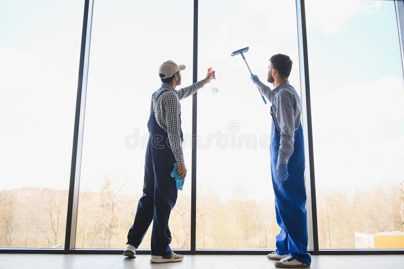Multiethnic Professional Cleaners in Uniform Washing Large Windows in ...