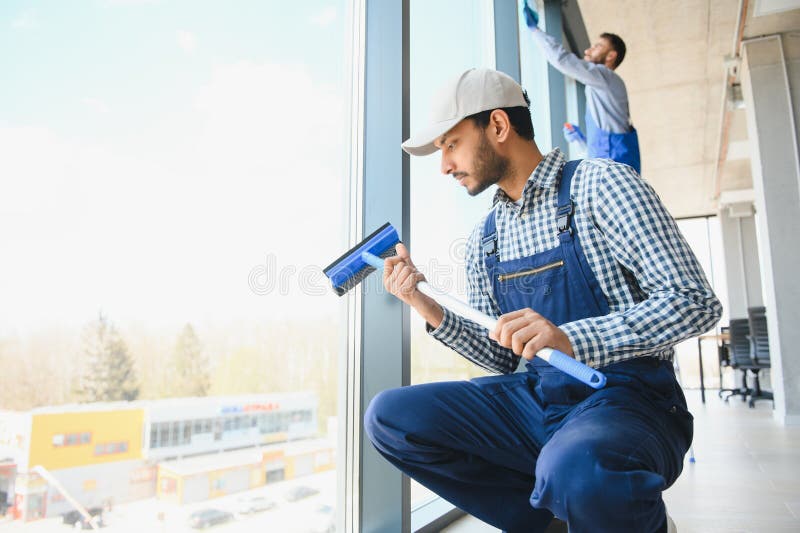 Multiethnic Professional Cleaners in Uniform Washing Large Windows in ...