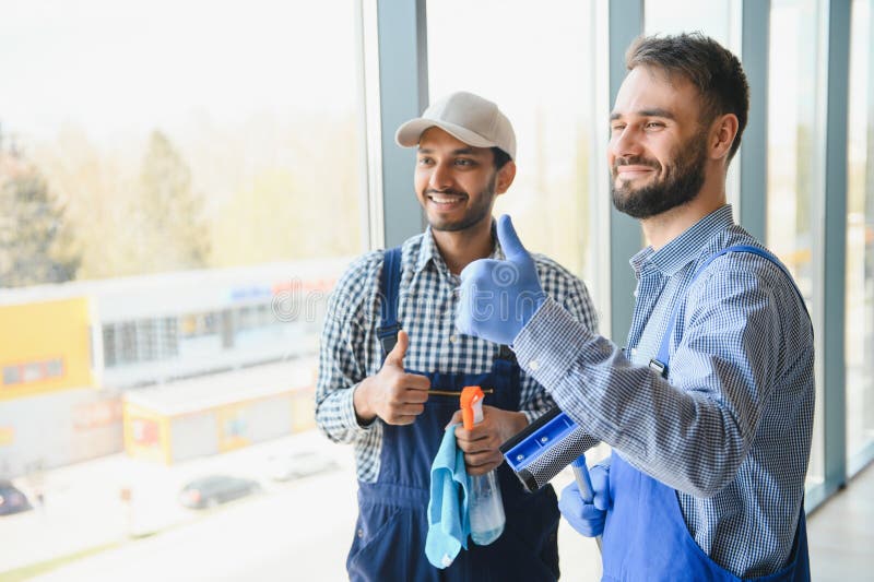 Multiethnic Professional Cleaners in Uniform Washing Large Windows in ...