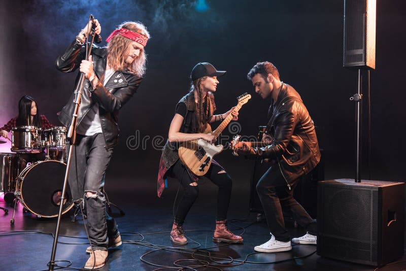 Multiethnic Rock and Roll Band Performing Music on Stage Stock Photo ...