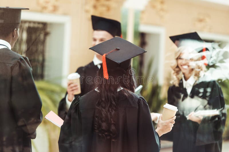 Multiethnic Students in Graduation Costumes with Disposable Cups of ...