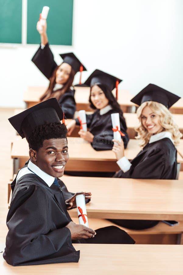 Students in Graduation Caps Holding Diplomas and Smiling at Camera ...