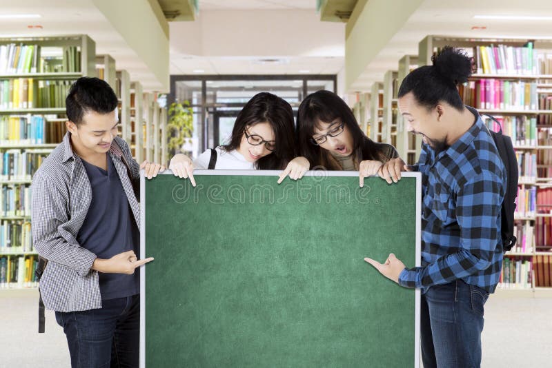 Students Hold Back To School Text in Library Stock Photo - Image of ...