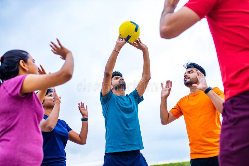 Multiethnic Team Group Playing Beach Volley on Sun Light Stock Image ...