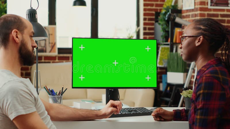 Multiethnic Team of People Looking at Computer with Greenscreen Stock ...