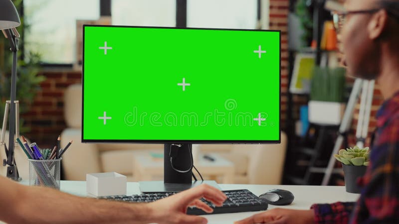 Multiethnic Team Working on Computer with Greenscreen at Home Stock ...