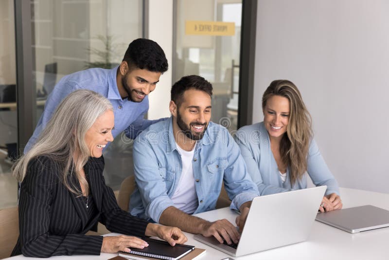Multiethnic Teammates Using Laptop during Group Meeting in Modern ...