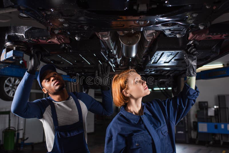 Multiethnic Technicians in Uniform Checking Bottom Stock Photo - Image ...