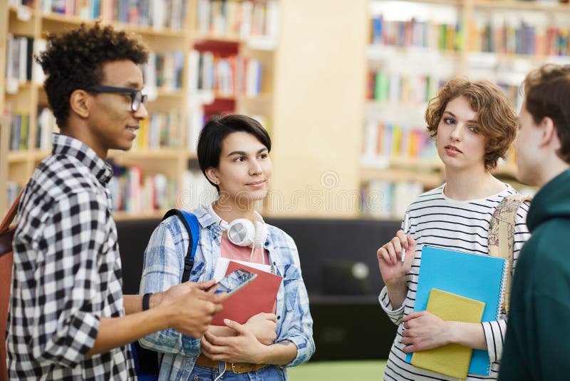 Multiethnic University Students Talking in Library Stock Photo - Image ...