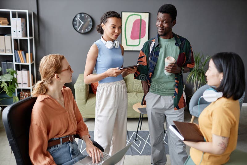 Multiethnic Young Business Team Brainstorming Ideas Standing in Office Stock Photo - Image of ...