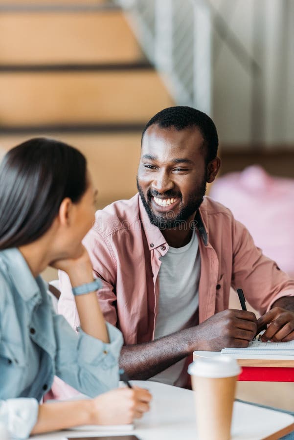Multiethnic Young Students Chatting at Classroom Stock Photo - Image of ...