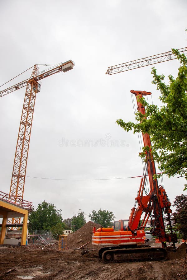 A Multifunctional Drilling Rig Stands between Two Cranes on a ...