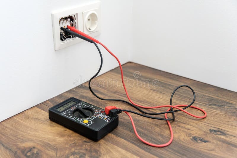 The Multimeter is on the Table. Measuring Voltage with a Tester Stock ...