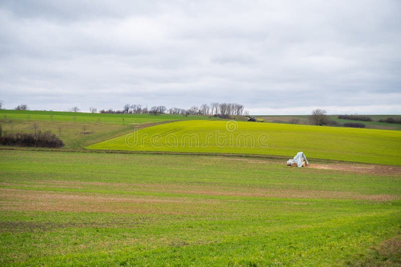 Multiple Agricultural Fields Landscape with a Tractor with Trailer in ...