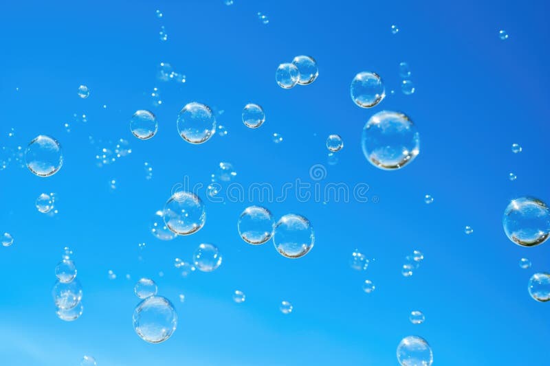 Multiple Bubbles Floating Against a Clear Blue Sky Stock Photo - Image ...