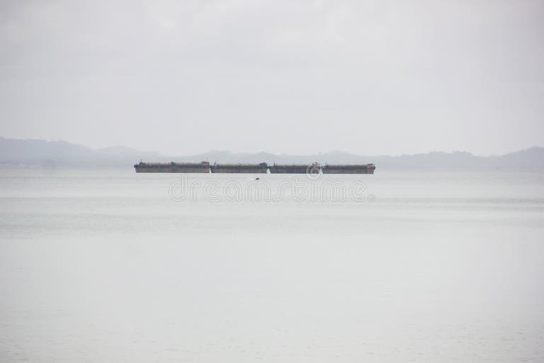 Multiple Cargo Barges Floating at Sea Under Gray Sky Stock Photo ...