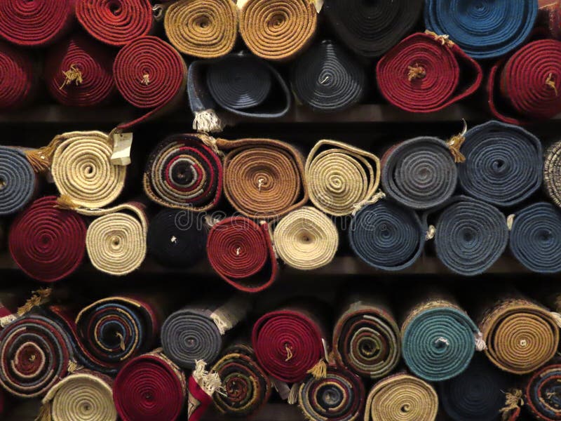 Multiple Colorful Rolled Carpets and Rugs Stacked on a Rack Stock Image ...