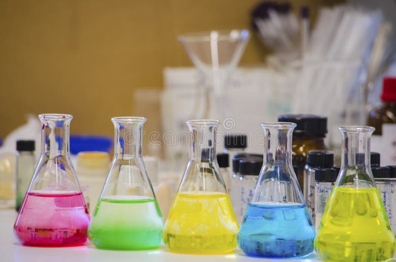 Colorful Solution in Conical Flask Lined on a Bench in a Chemistry Lab ...